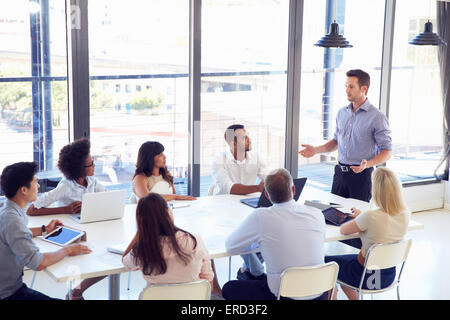 Businessman presenting to colleagues Stock Photo - Alamy
