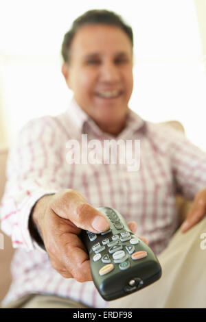 Senior Hispanic Man Using TV Remote Control Stock Photo - Alamy