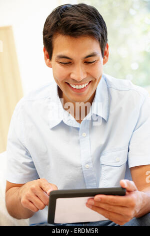Asian man using tablet Stock Photo - Alamy