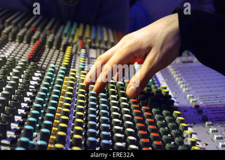 Mixing desk with hand Stock Photo - Alamy