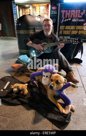 Homeless Busker with guitar, playing music, musician, street ...