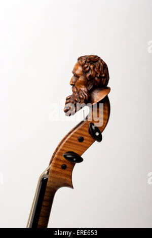Carved head at the top of a violin scroll. Violin labelled ...