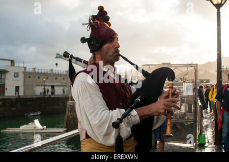 Basque man in traditional dress standing next to cattle, during Aste ...