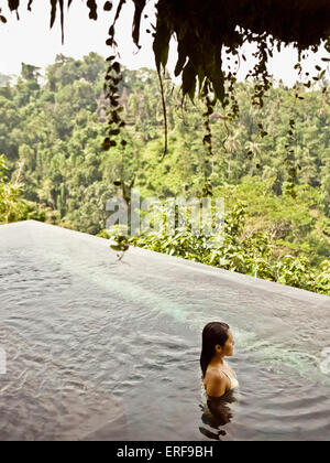 Indonesia, Bali, Ubud. Infinity Pool overlooking forest at sunrise ...