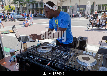 An African-American DJ playing music at an outdoor event - USA Stock ...