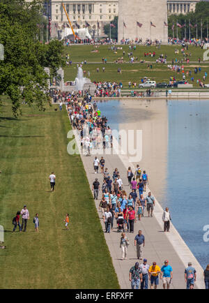 People walk along the National Mall inside the Great American State ...