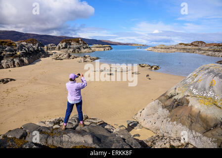 Woman and dog on Ardtoe beach, Ardnamurchan Peninsula, Lochaber ...