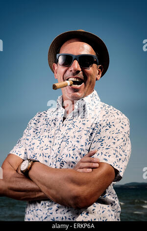 Man smoking cigar at beach Stock Photo - Alamy
