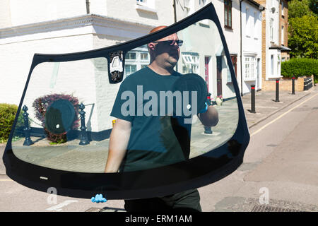 Windscreen fitter from Screen-Tec Windscreens carrying / fitting a ...