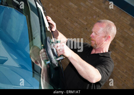 Windscreen fitter from Autoglass fitting a replacement windscreen to a ...