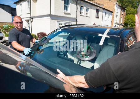 Windscreen fitter from Screen-Tec Windscreens carrying / fitting a new ...