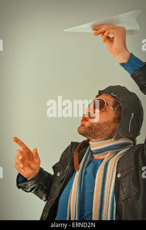 Aviator pilot with hat and sunglasses plays with paper planes Stock ...