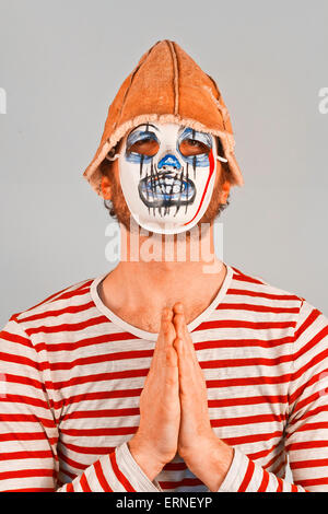 Weird scary masked mime in striped red and white shirt Stock Photo - Alamy