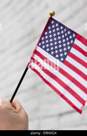 Waving three American flags in support the United States and freedom ...