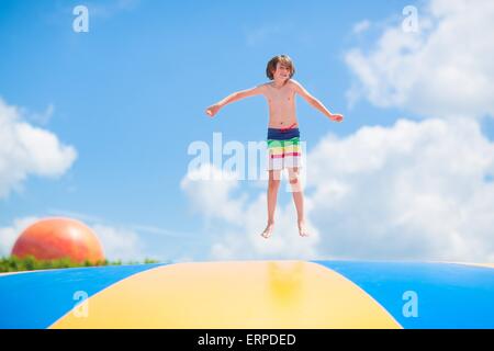 Happy family jumping on trampoline Stock Photo - Alamy