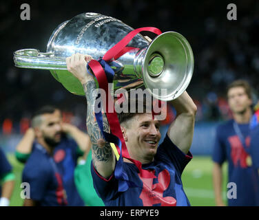 Barcelona's Lionel Messi celebrates with the trophy after the UEFA ...