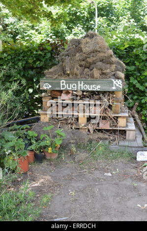 Bug house built out of recycled pallets, wood, twigs and sods of earth ...