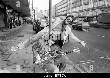 Guitarist Gerry Cott (standing) and bass player Peter Briquette from ...