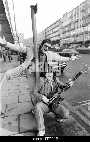 Guitarist Gerry Cott (standing) and bass player Peter Briquette from ...