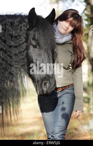 woman and Frisian horse Stock Photo - Alamy