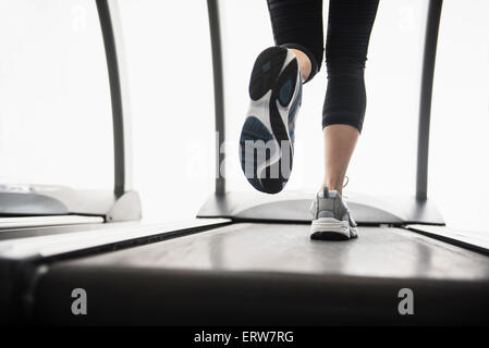 Athletic woman running on treadmill during fitness workout Stock Photo ...