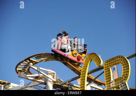 June 2015 - People enjoy the Crazy Mouse roller coaster fairground ride ...
