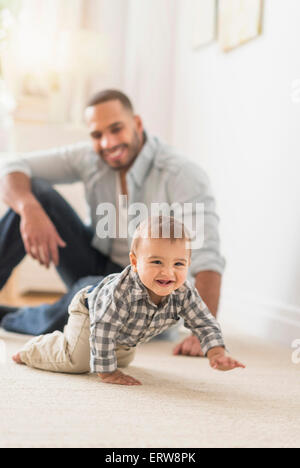 Happy Crawling Baby Boy and Mixed Race Parents Playing in the Park ...