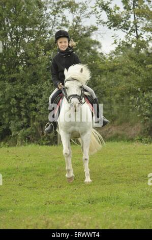 girl rides pony Stock Photo - Alamy