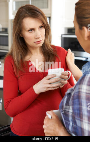 Sad Woman Being Consoled At Home By Female Friend Stock Photo - Alamy