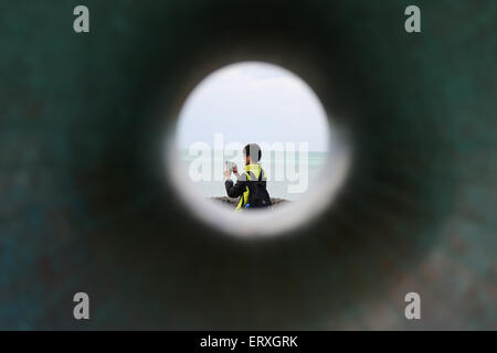 "Afloat" a huge circular donut shaped globe cast in bronze on a groyne ...