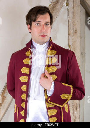 Lackey in victorian livery costume presenting a message on parchment ...