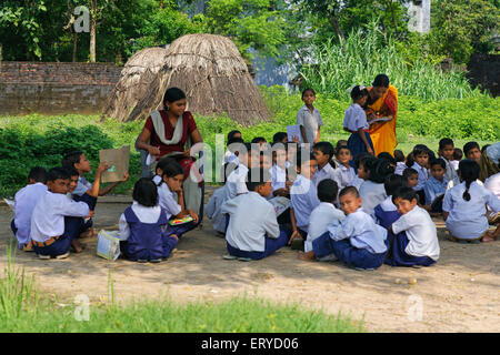 Indian children education under a tree ; open air rural school ...