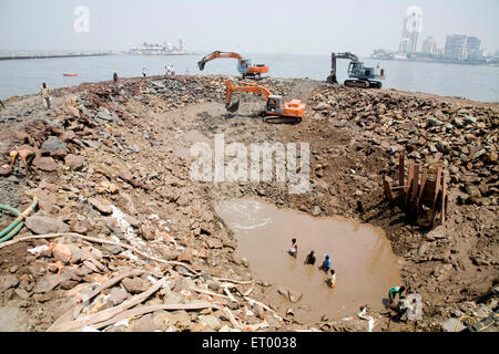 An Indian man digging a hole Stock Photo - Alamy