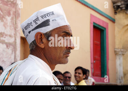 Supporters of Aam Aadmi Party (AAP) carry brooms, their party's symbol ...