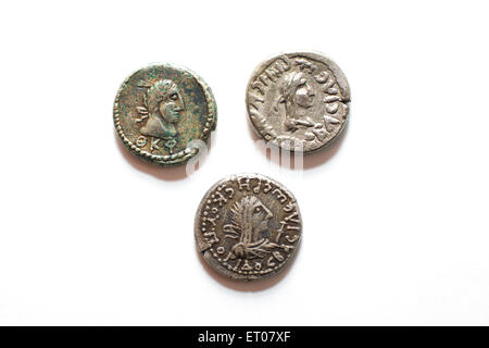 A lot of old silver coins with portraits of kings on a white background ...