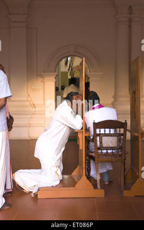 People making confession is Christian faith and practice Kerala India ...