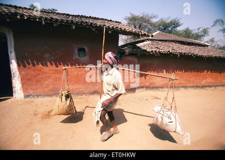 Traditional merchant sells grain home to home in exchange of old things ...