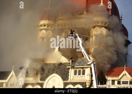 Fire brigade officers putting off fire at Taj Mahal hotel burnt by ...