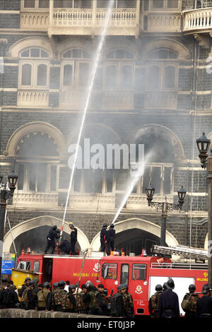 Fire brigade officers putting off fire at Taj Mahal hotel burnt by ...