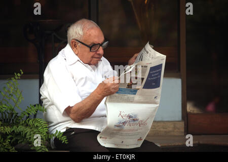 Senior Tata Officer Rusy Modi with newspaper sitting at stairs of his ...