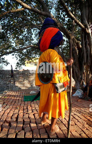 Nihang or Sikh warrior in pagdi or headgear carrying sword and wooden ...