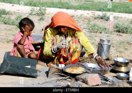 Rural Indian Woman cooking food in the Kitchen using firewood stove ...