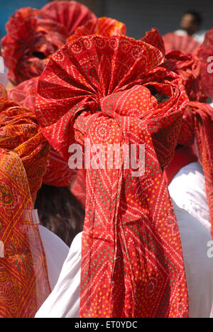 Indian men wearing turbans and red colour on their face standing in ...