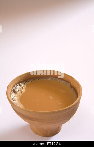 Hot tea with milk in earthen clay pot kulhad chai on white background ...