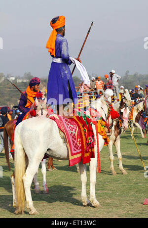 Sikh warrior balancing on horse running in hola mohalla festival ...