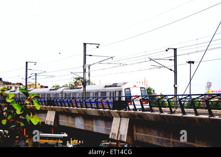Metro train on bridge at junction of panchkuan road, New Delhi, India ...