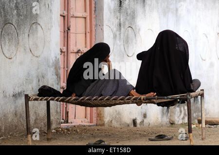Old women sitting on charpoy outside house at Mindiyada near Anjaar ...