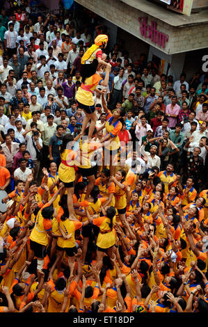 Indian crowds of a human pyramid to break the Dahi handi an earthen pot ...
