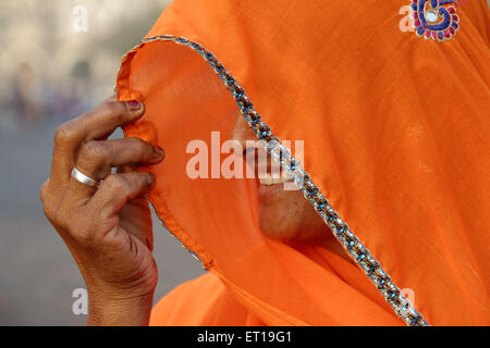 Hindu Indian women, covering their faces with Sari, with bindi or Pottu ...