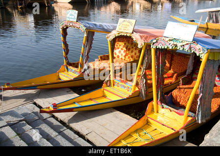 A wooden boat (shikara) in Dal Lake, Srinagar, Kashmir on a beautiful sunset evening Stock Photo ...